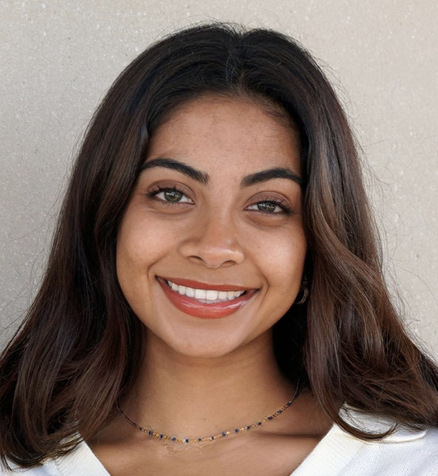 A person smiling at the cameraDescription automatically generated